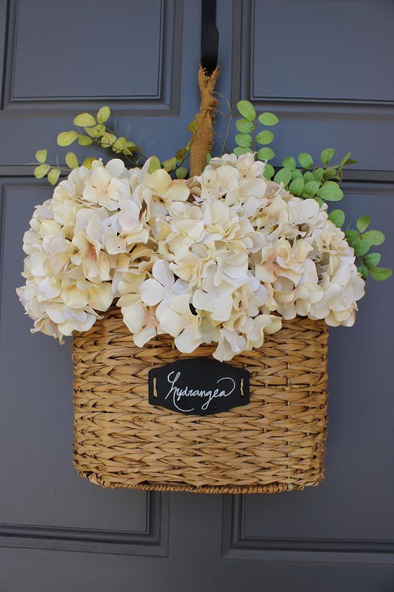 Beautiful spring decorations on the front door based on a wicker basket ...