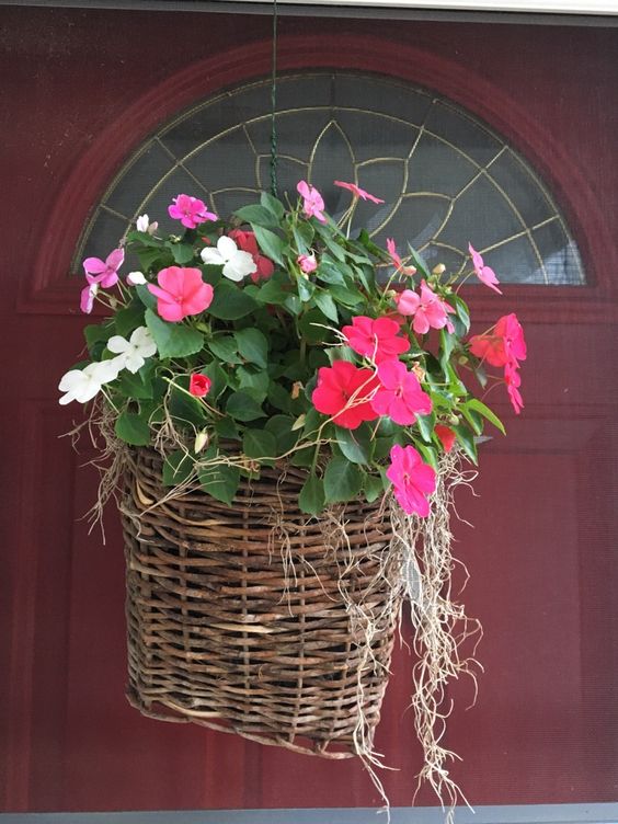 Beautiful spring decorations on the front door based on a wicker basket ...