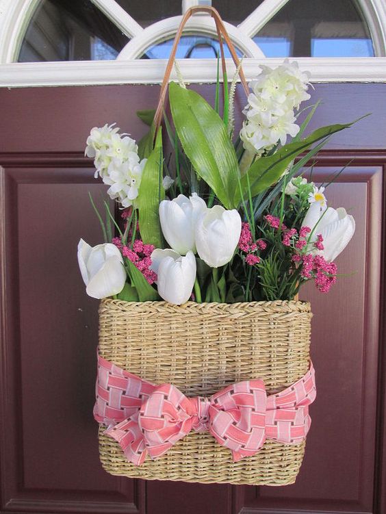 Beautiful spring decorations on the front door based on a wicker basket ...