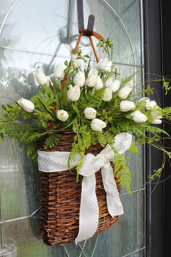 Beautiful spring decorations on the front door based on a wicker basket ...