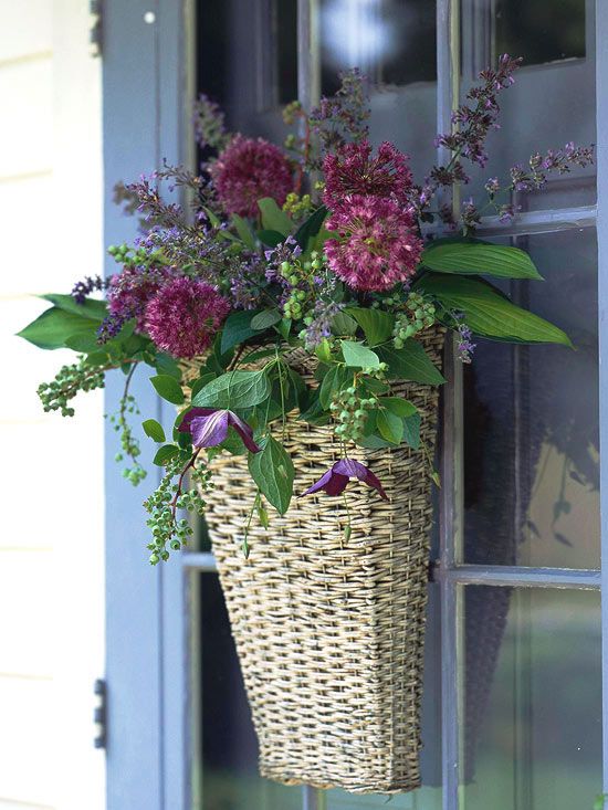 Beautiful spring decorations on the front door based on a wicker basket ...